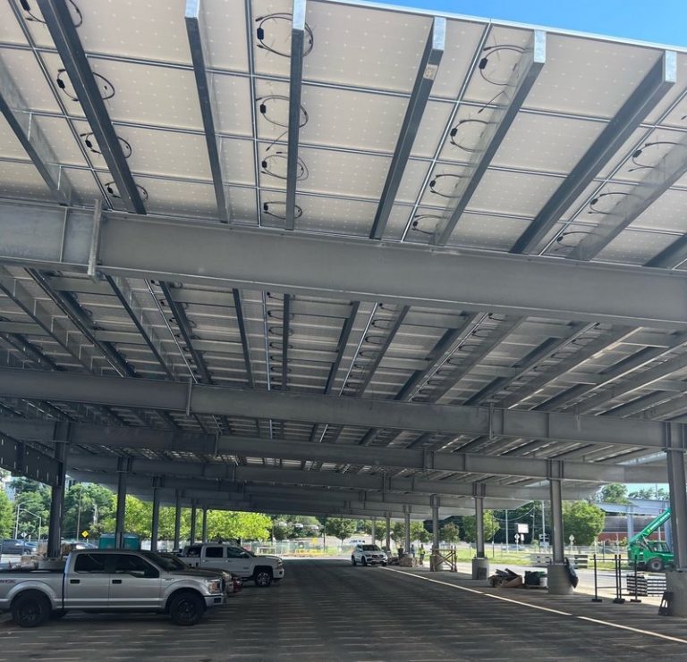 Solarizing parking lots with solar carports or elevated solar trackers