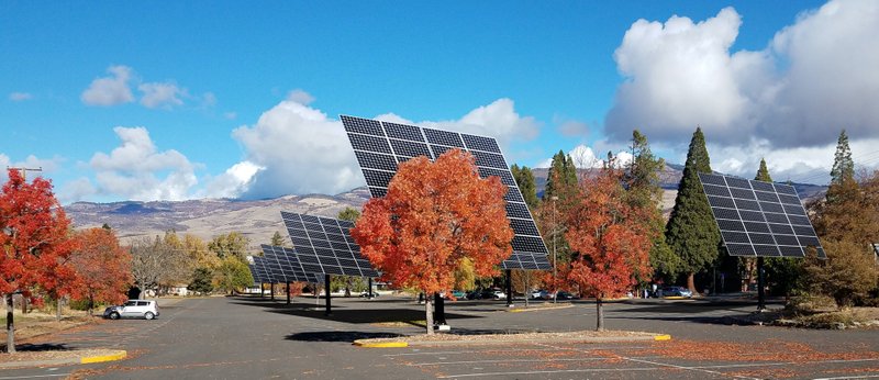 Solarizing parking lots with solar carports or elevated solar trackers